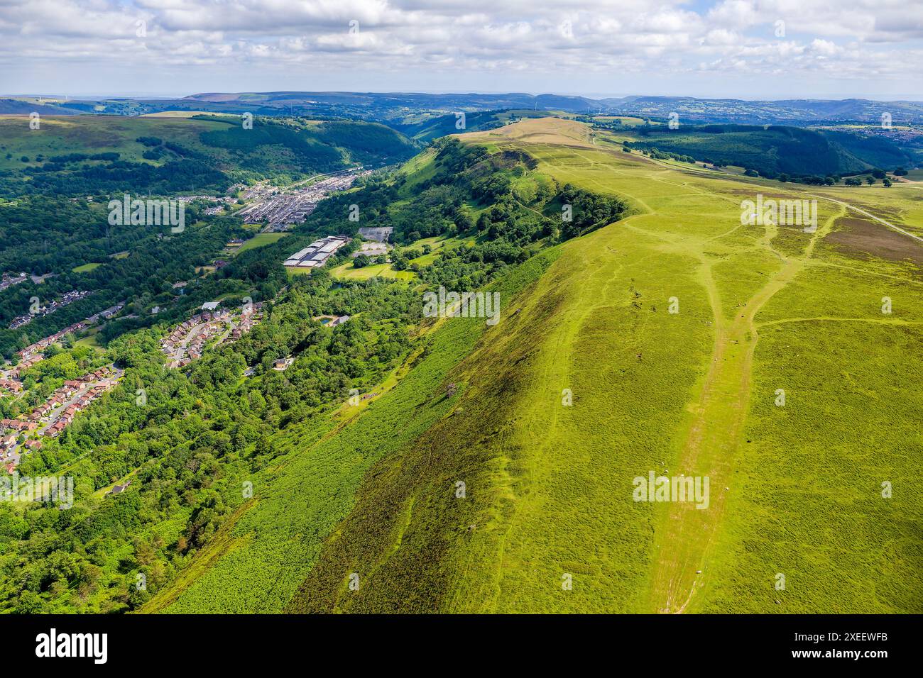 Green hills, trees and a small town in a deep valley Stock Photo - Alamy