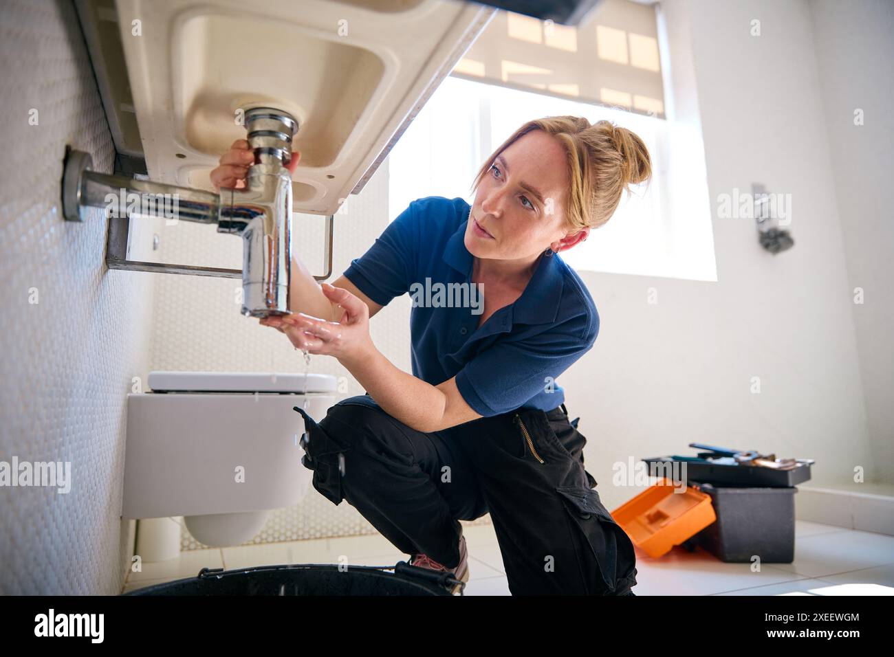 Plumber fixing leak hi-res stock photography and images - Alamy