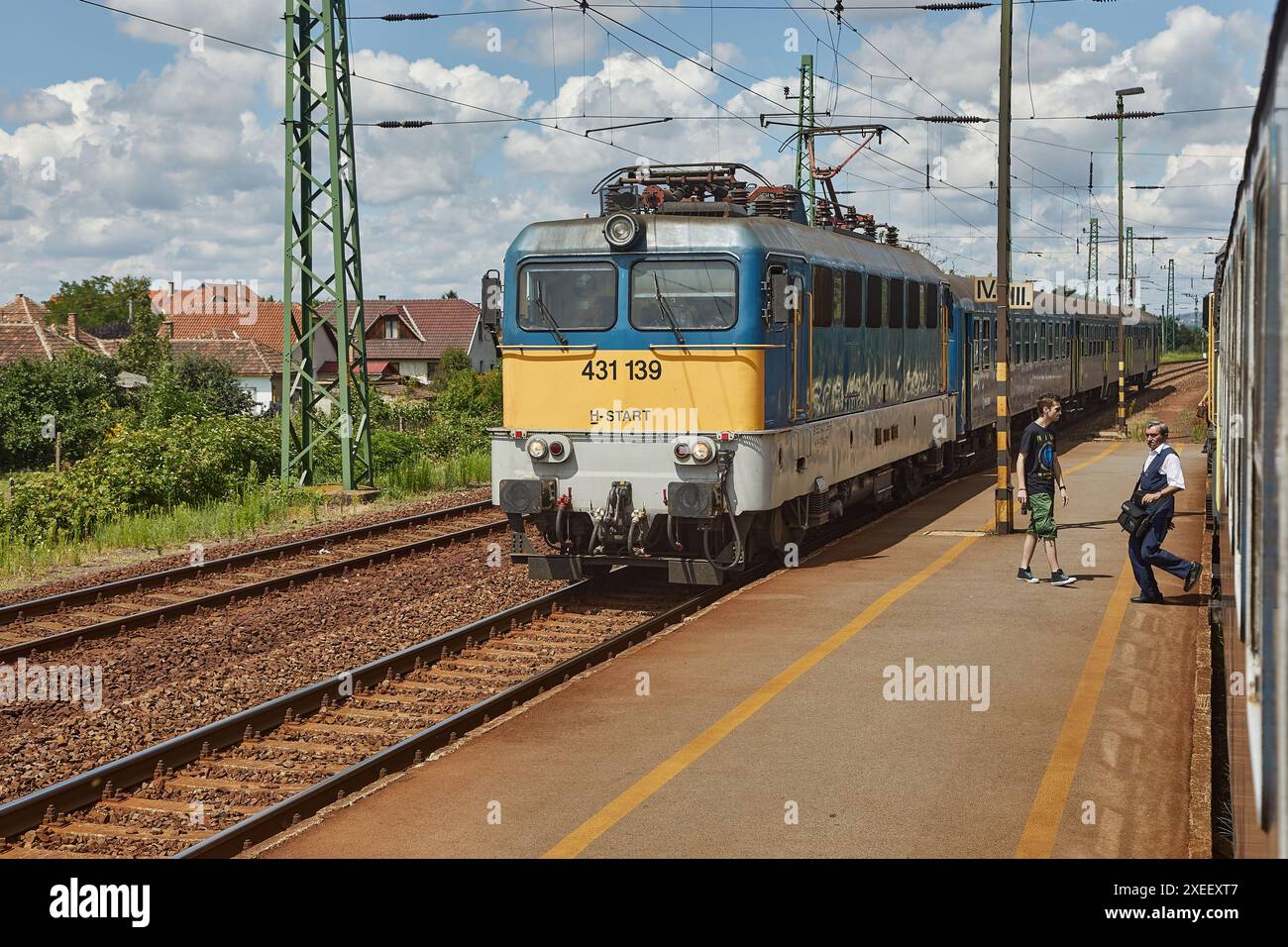 Railway station with passenger trains in Hungary Stock Photo - Alamy