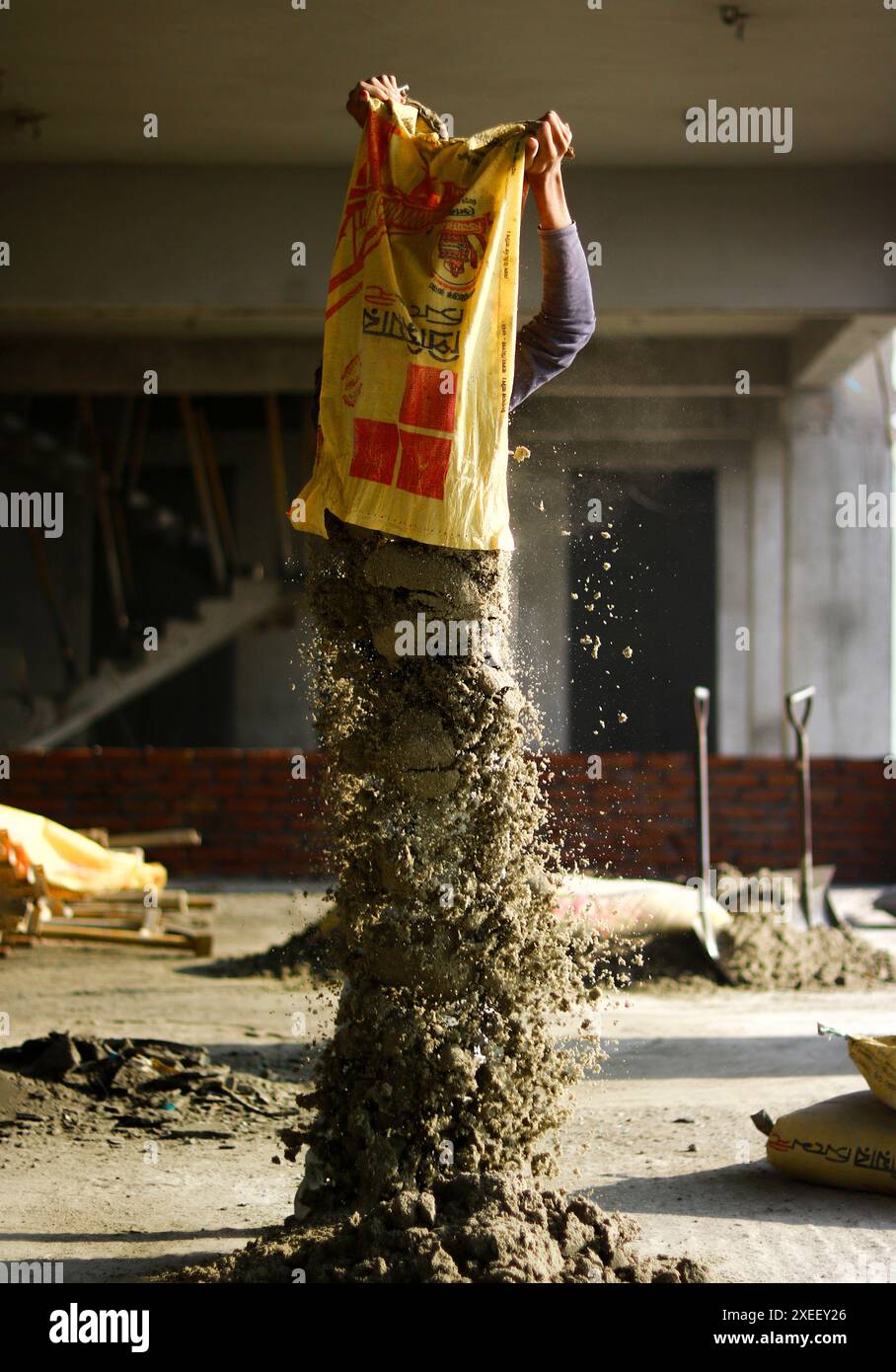 Construction worker unloading cement Stock Photo - Alamy