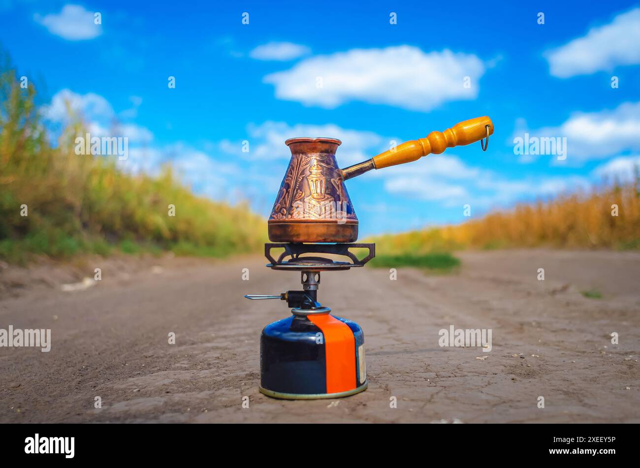Copper cezva turka for making coffee stands on a tourist gas burner ...
