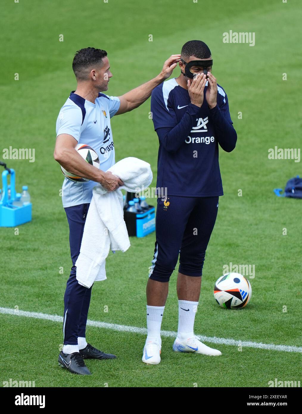 France's Kylian Mbappe adjusts his protective mask during a training ...