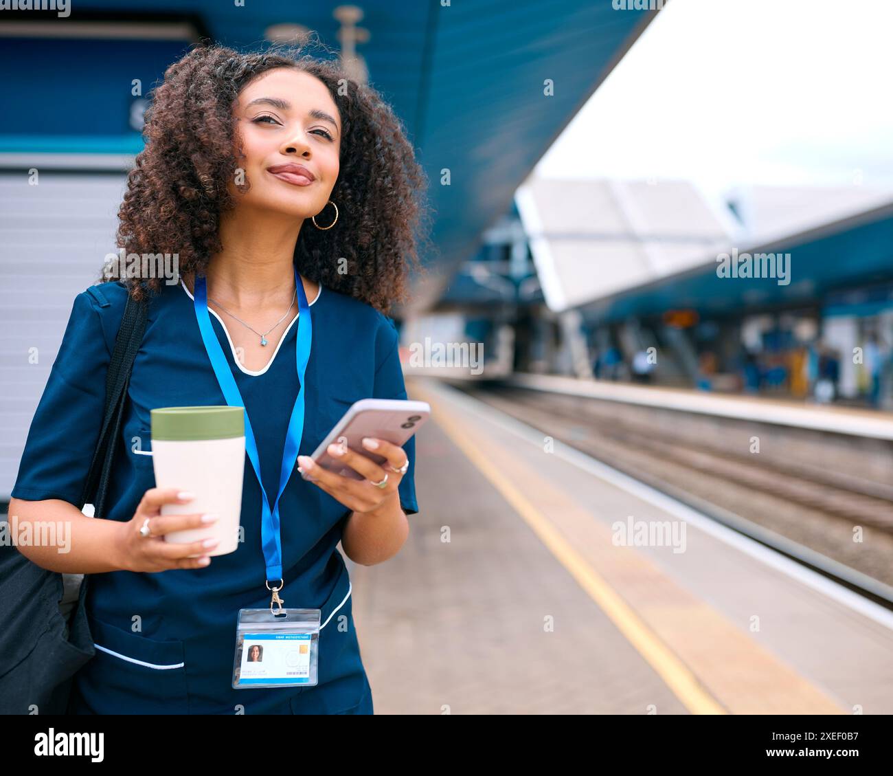 Female Doctor Or Nurse Commuting On Train Platform With Mobile Phone ...