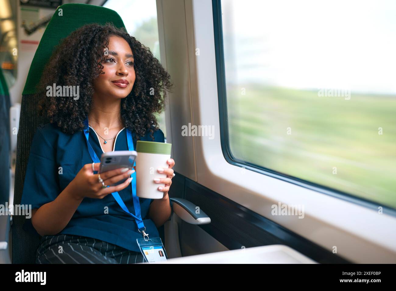 Female Doctor Or Nurse Commuting On Train With Mobile Phone And ...