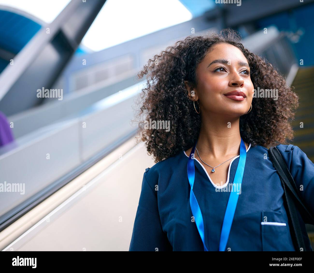 Female Doctor Or Nurse Commuting On Escalator At Railway Station To ...