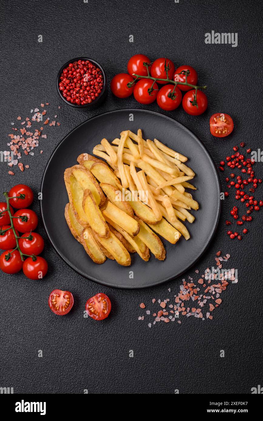 Delicious crispy french fries with salt and spices on a textured ...