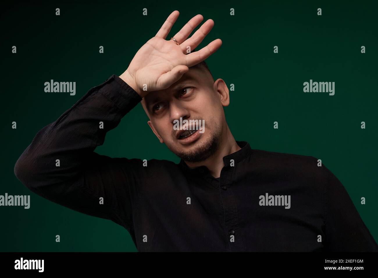Man Holding Hands Up to Head Stock Photo - Alamy