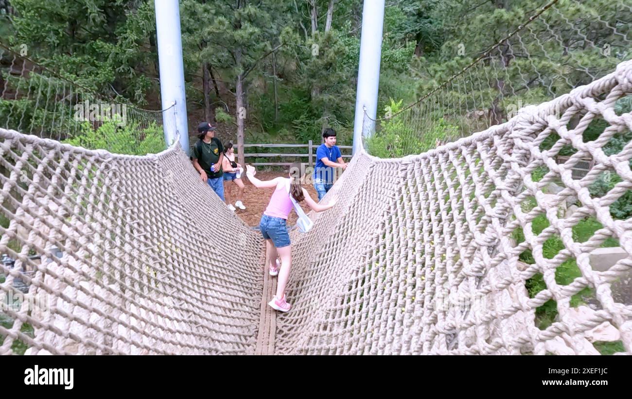 Children crossing rope bridge hi-res stock photography and images - Alamy