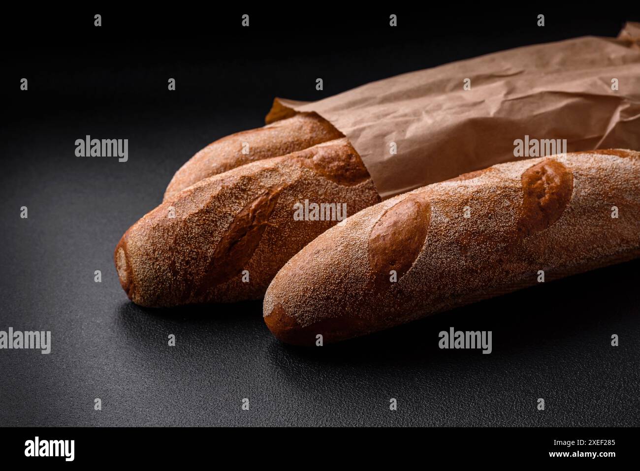 French baguette bread on a dark textured concrete background Stock ...