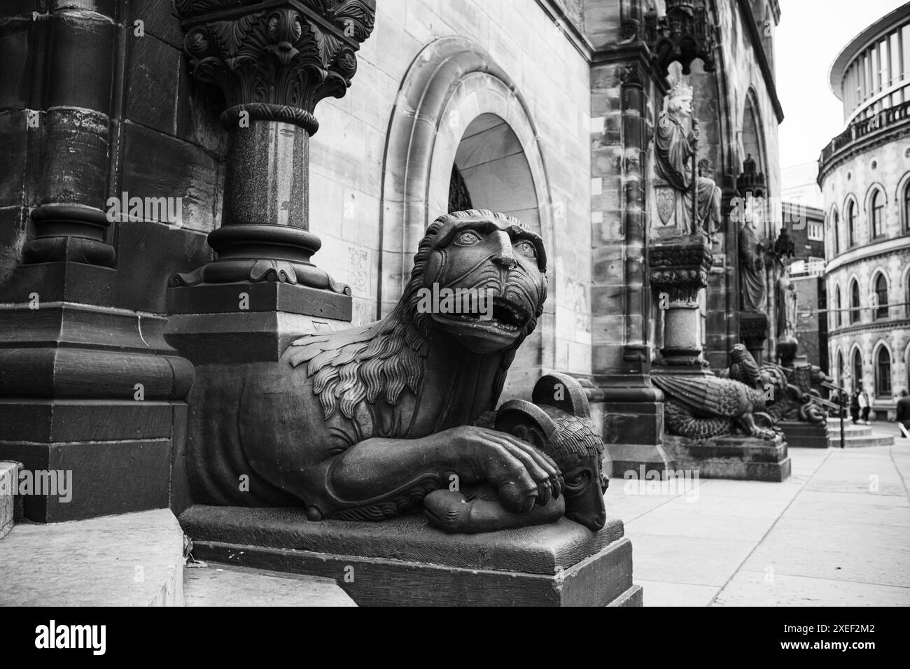 A decorative monster made of stone guards the entrance to an ancient ...