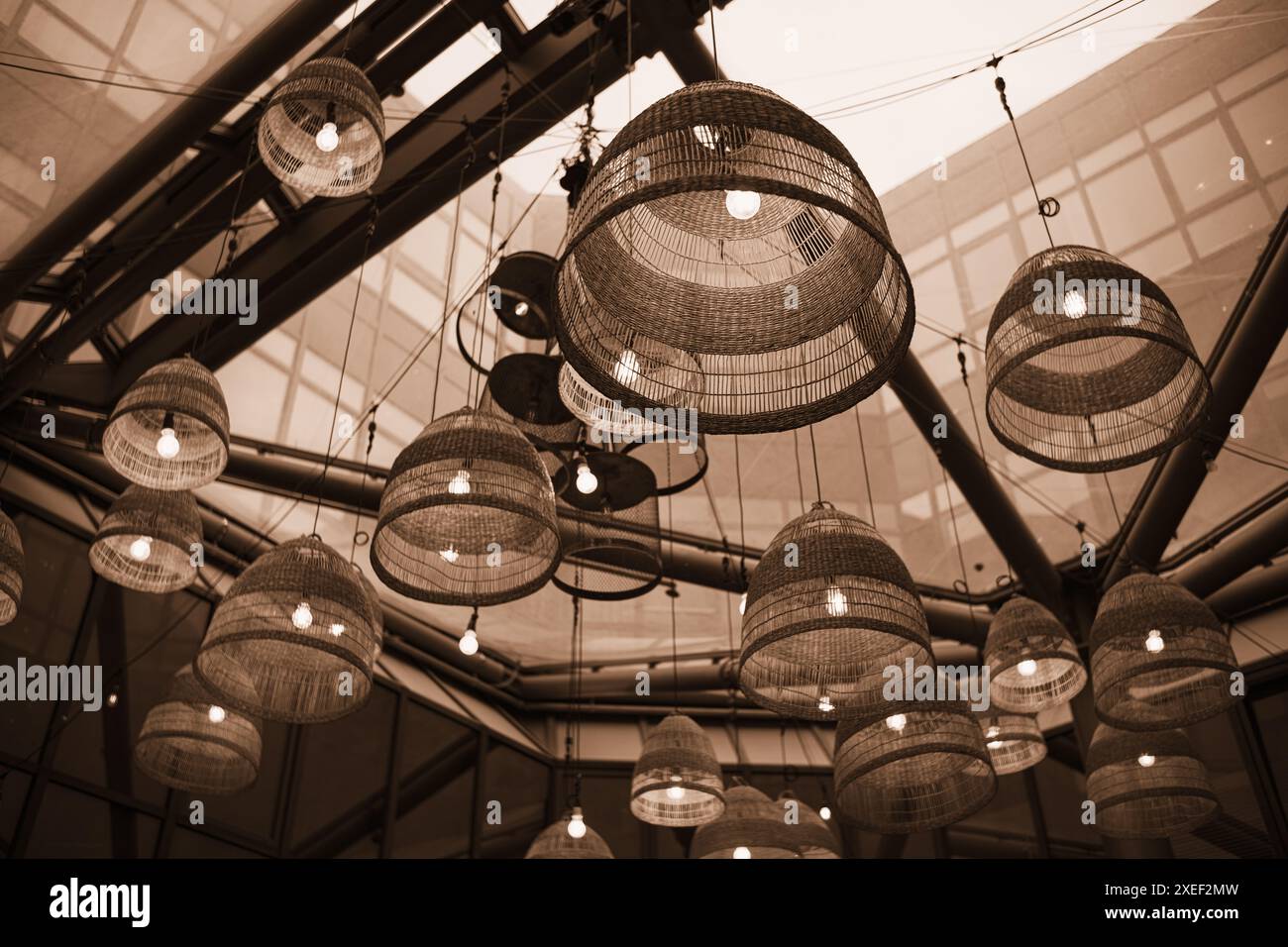 Lamps with wicker shades under a glass ceiling in modern business ...