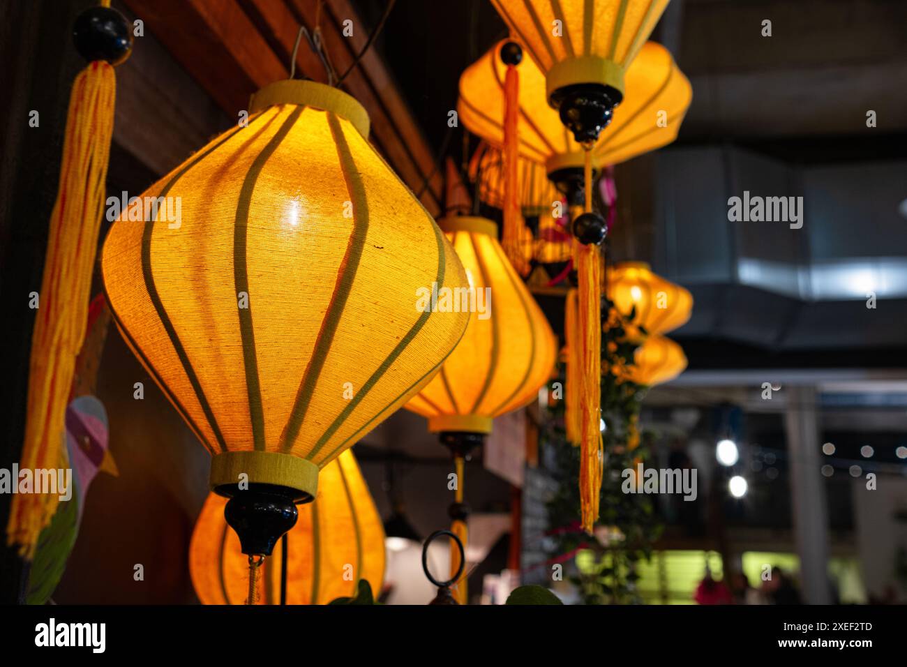 Yellow Asian lamps in the interior of the restaurant. Chinese style ...