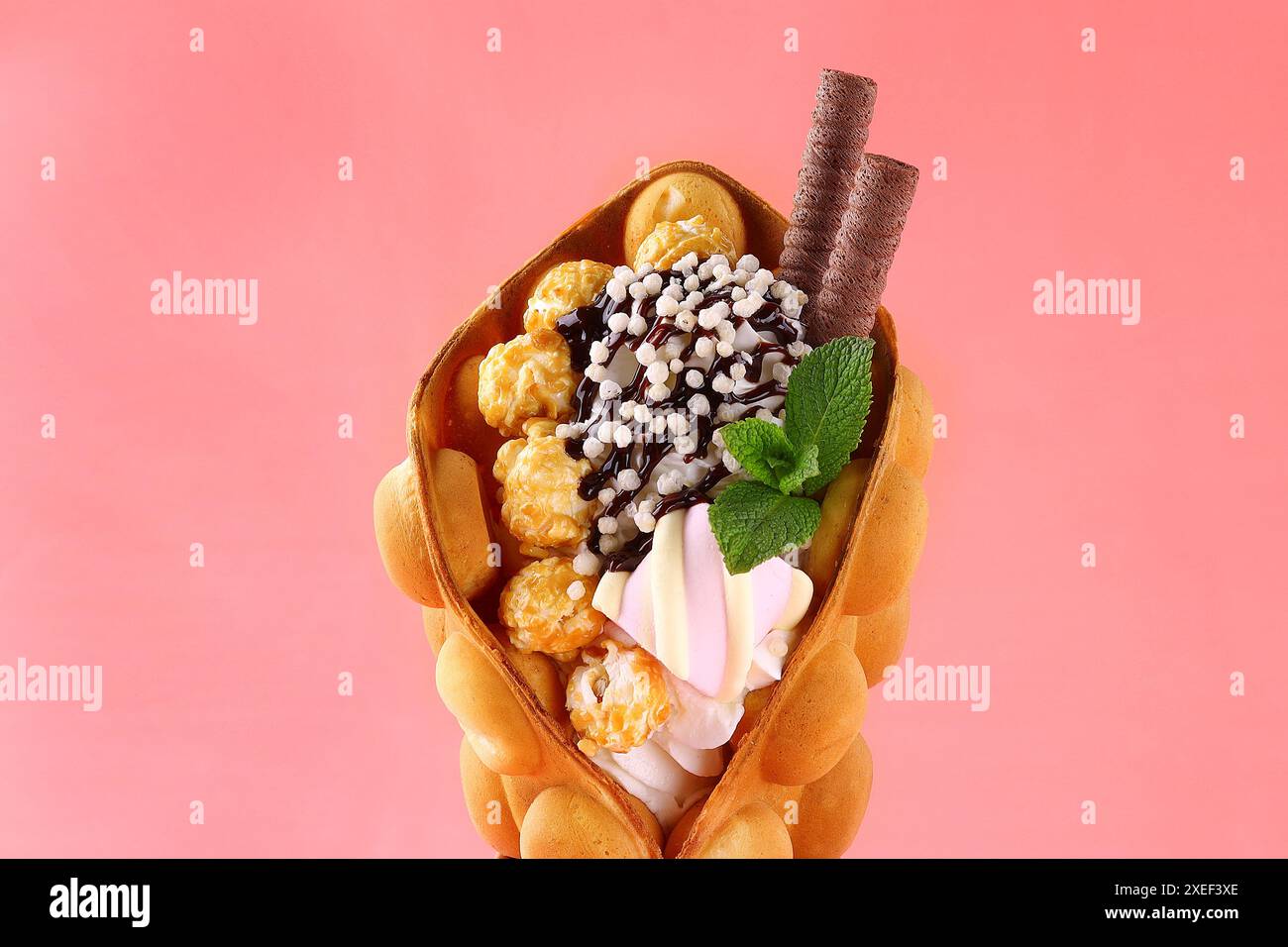 Hong kong or bubble waffle with ice cream, chocolate sauce and isolated ...