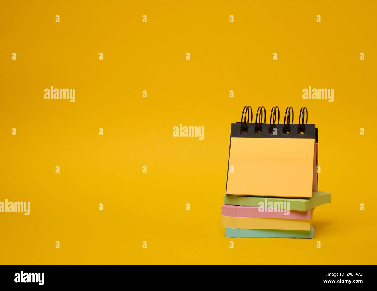 Stack of paper multi-colored stickers on a yellow background Stock ...