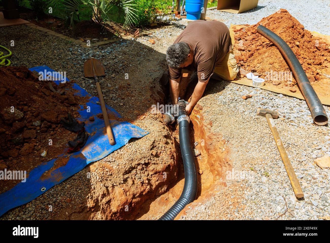 Assembling perforated flexible drain pipes for draining rainwater at ...