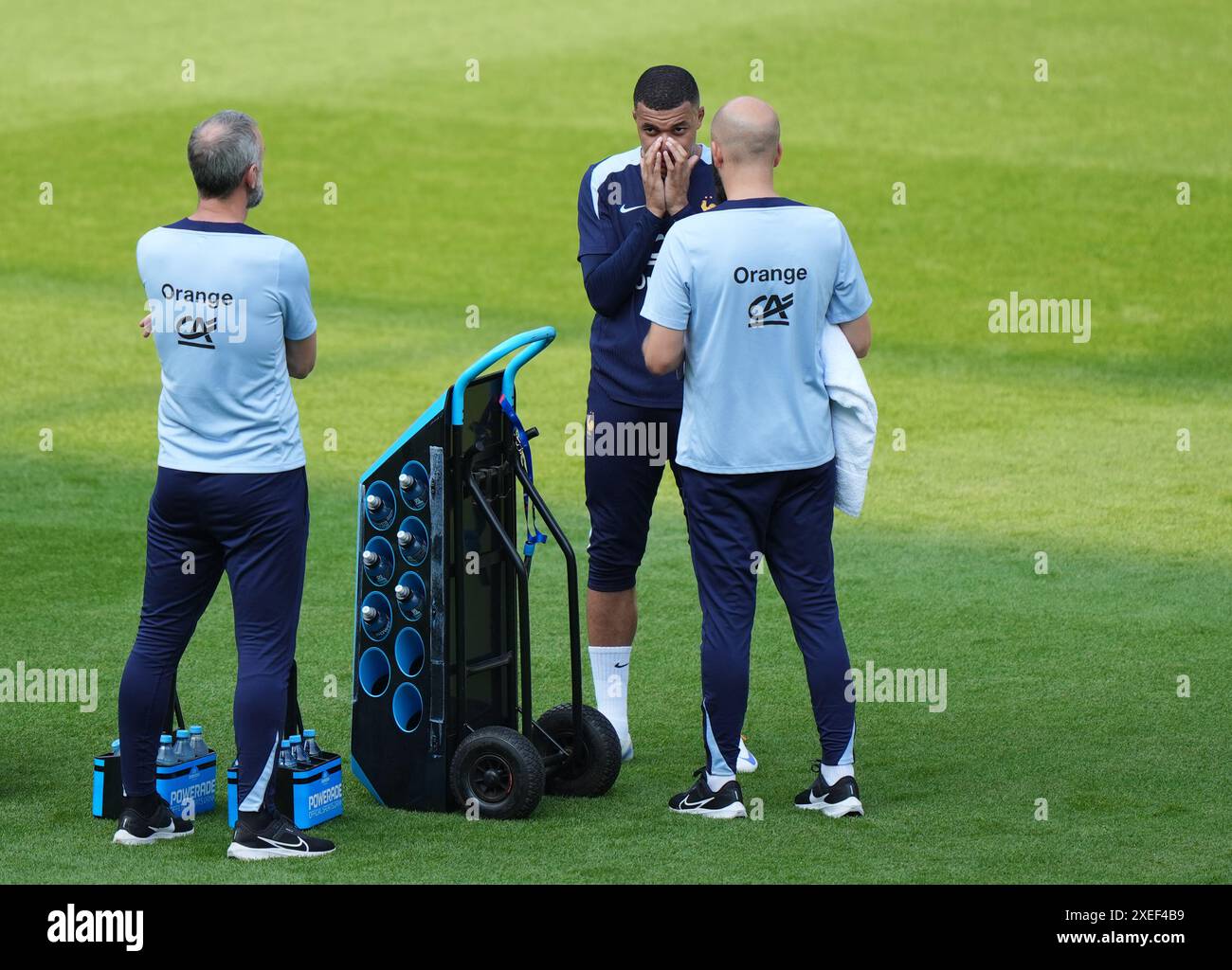 France's Kylian Mbappe gets help with his protective mask during a ...
