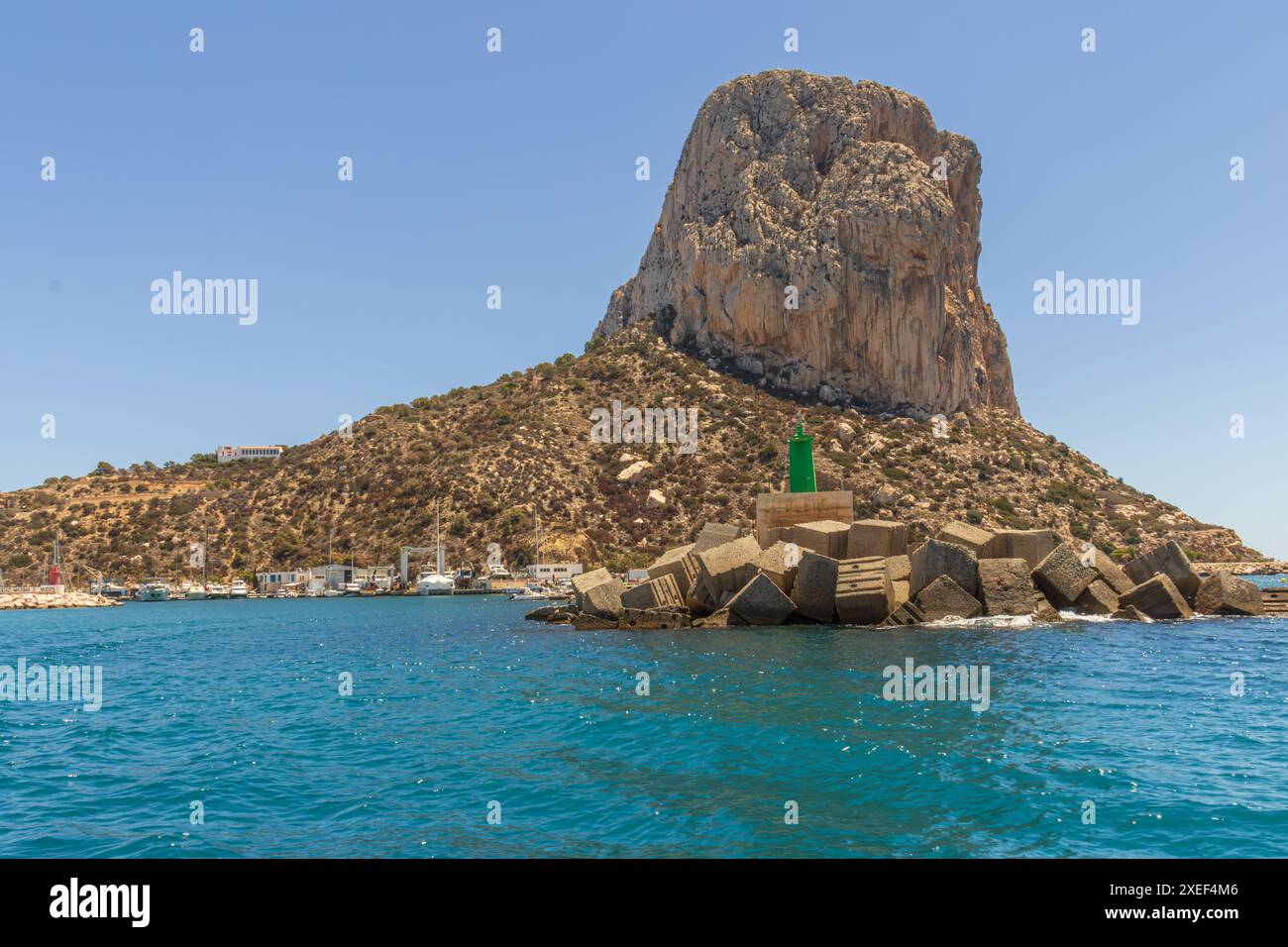 This image presents a breathtaking view of the Penon de Ifach, a ...