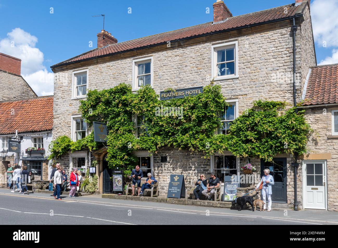 People sitting outside the Feathers Hotel in Helmsley, a pretty town in ...