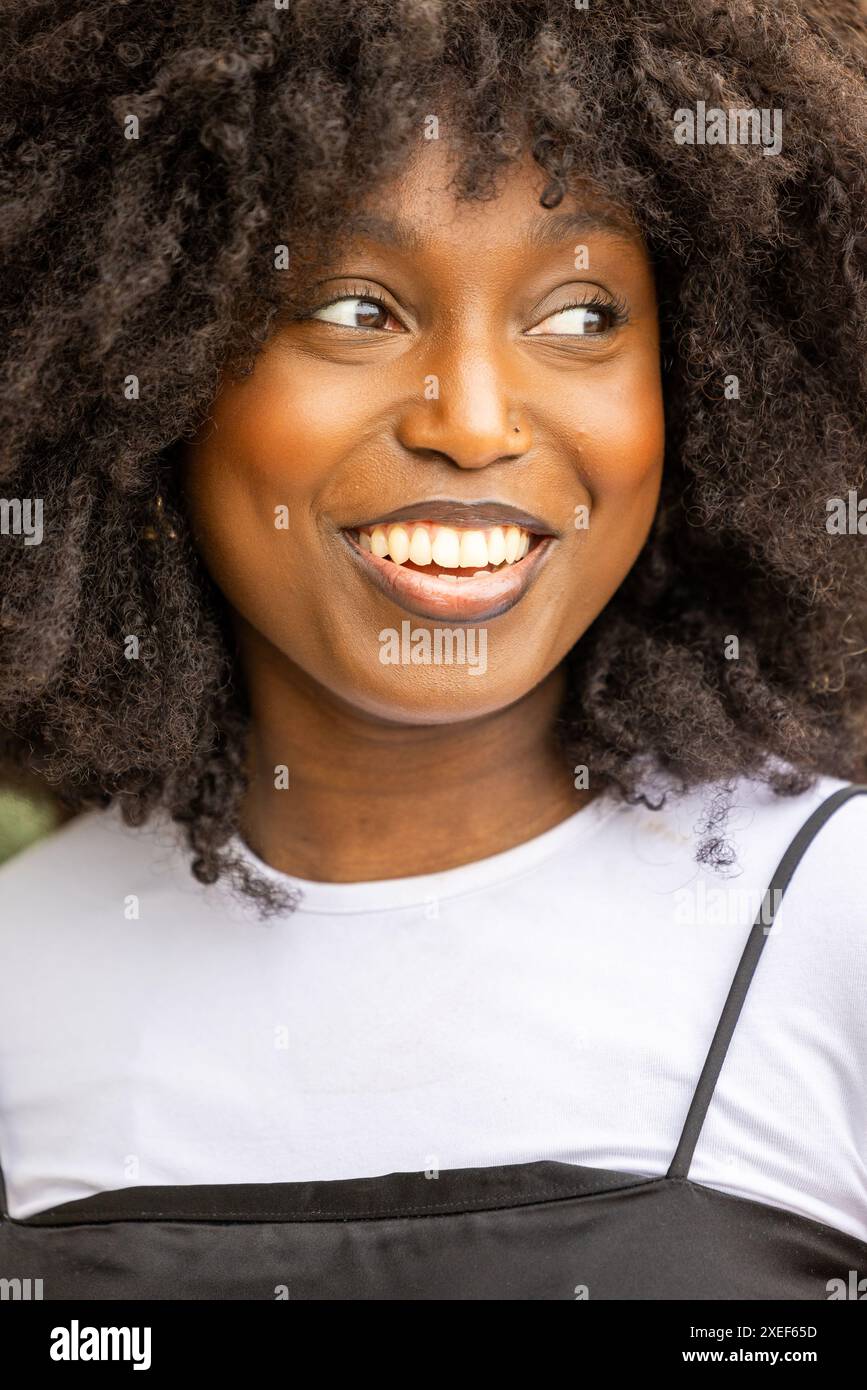Radiant Smile of a Young Black Woman with Natural Hair Stock Photo - Alamy