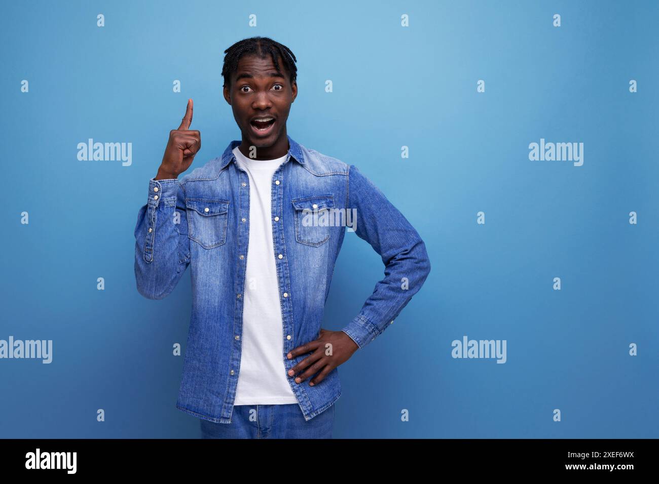 Smart stylish american young man with dreadlocks points finger to the ...