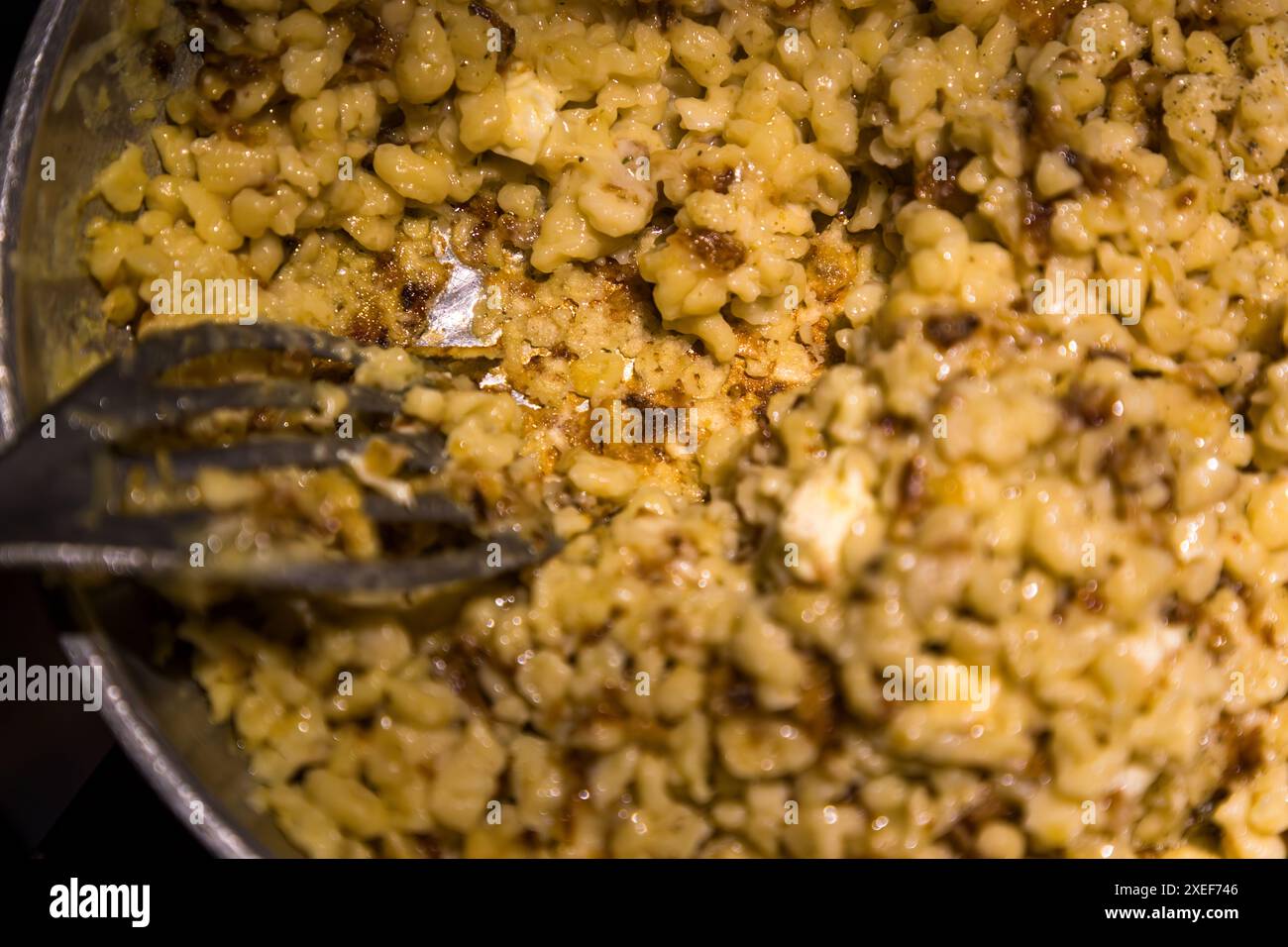 Homemade cheese spaetzle with fried onions and alpine cheese. Homemade ...