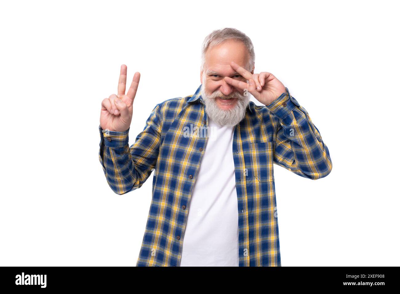 60s middle-aged gray-haired man with a beard in a shirt makes a face on ...