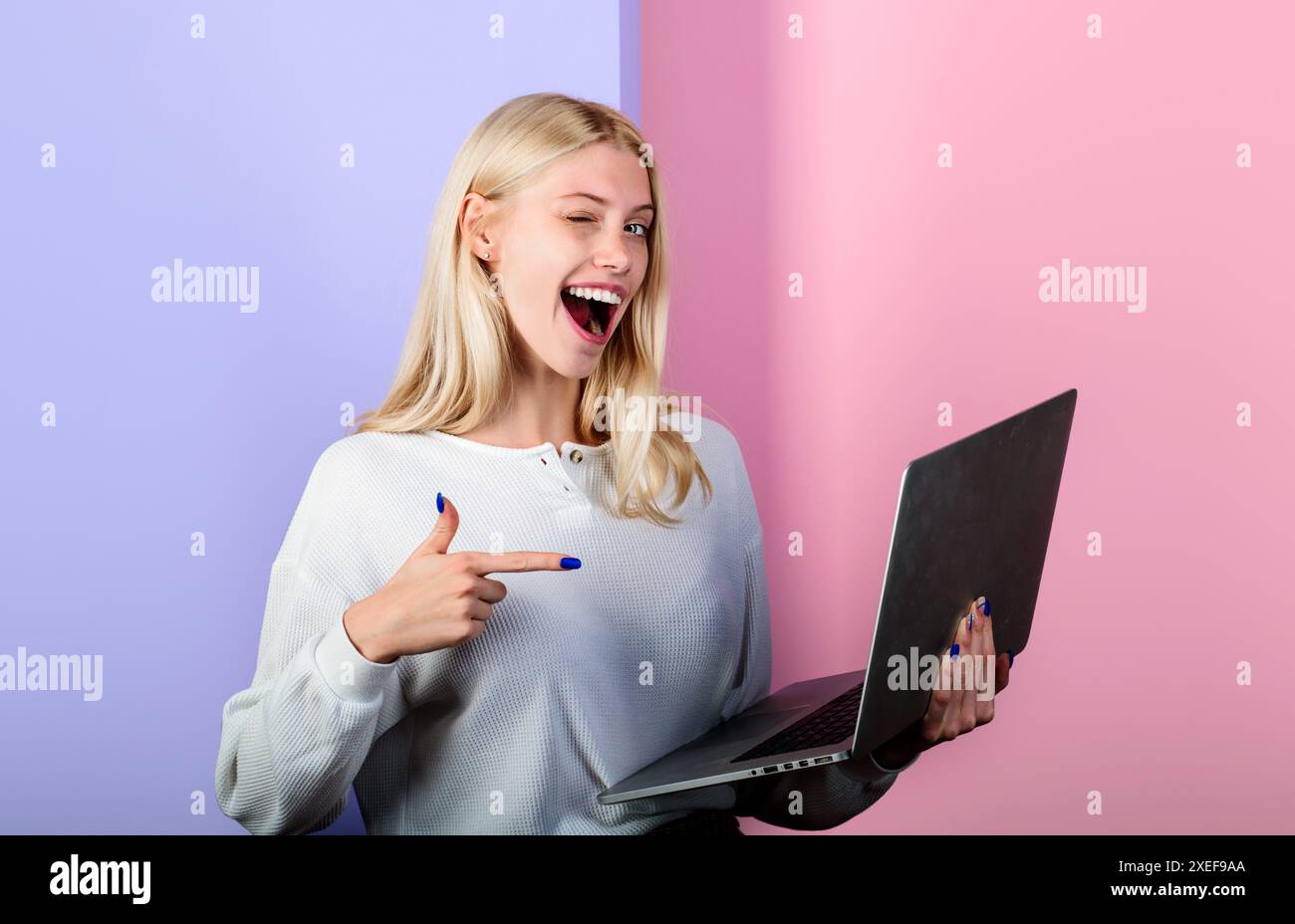 Beautiful girl holding laptop pointing hi-res stock photography and ...