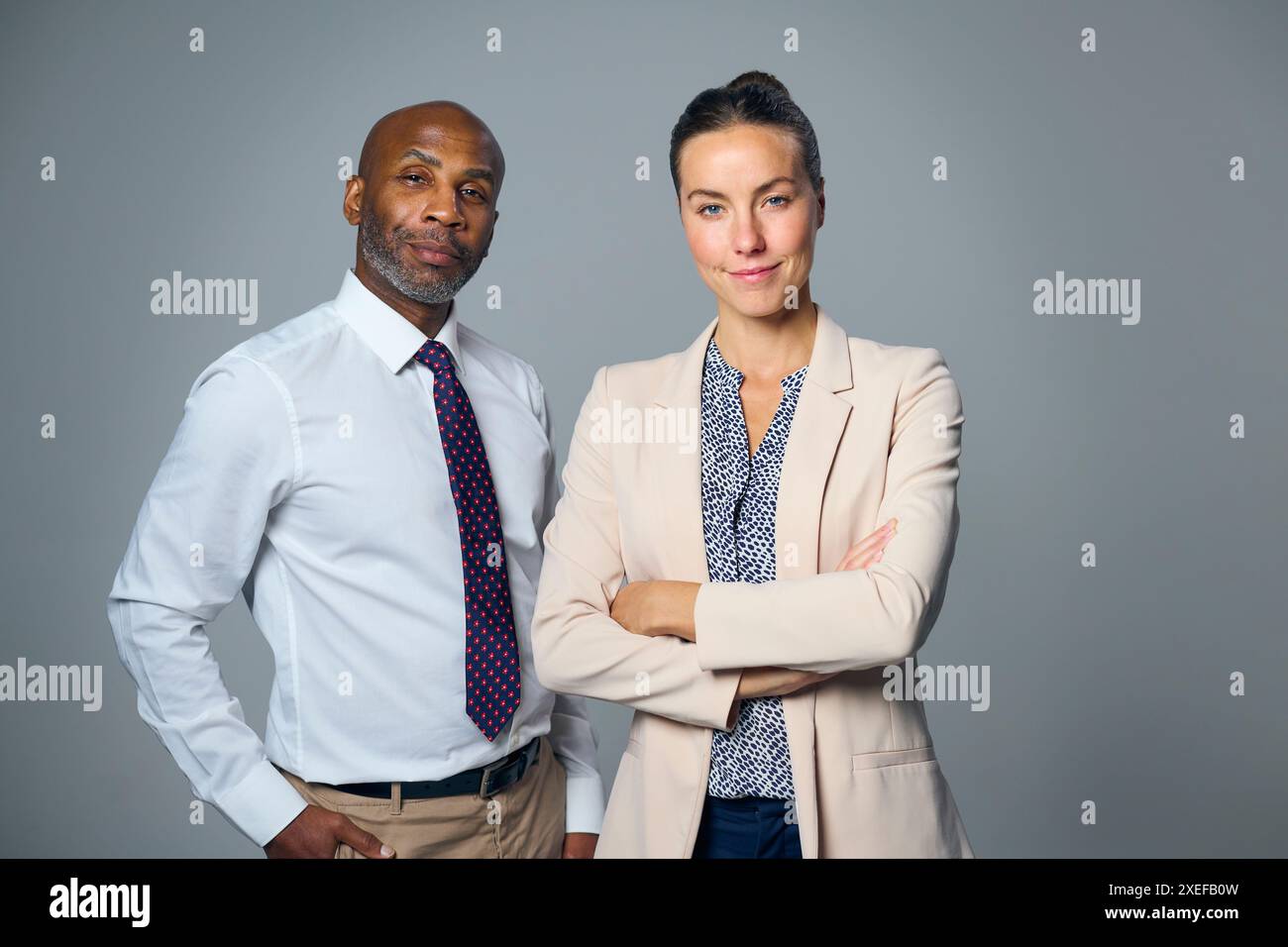 Studio Portrait Of Serious Businessman And Businesswoman Wearing Suits ...