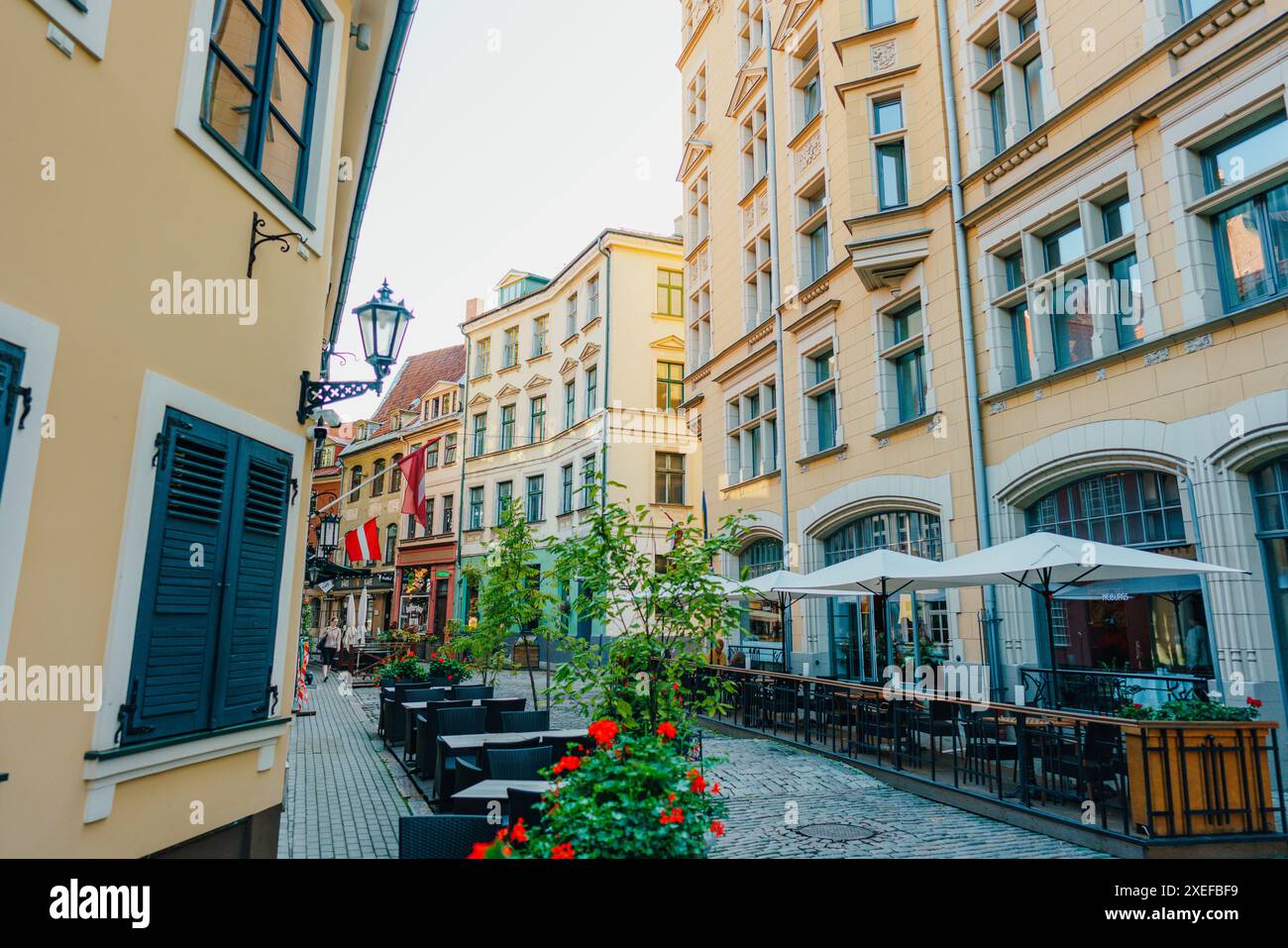 A charming European street with outdoor cafes and historic buildings in ...