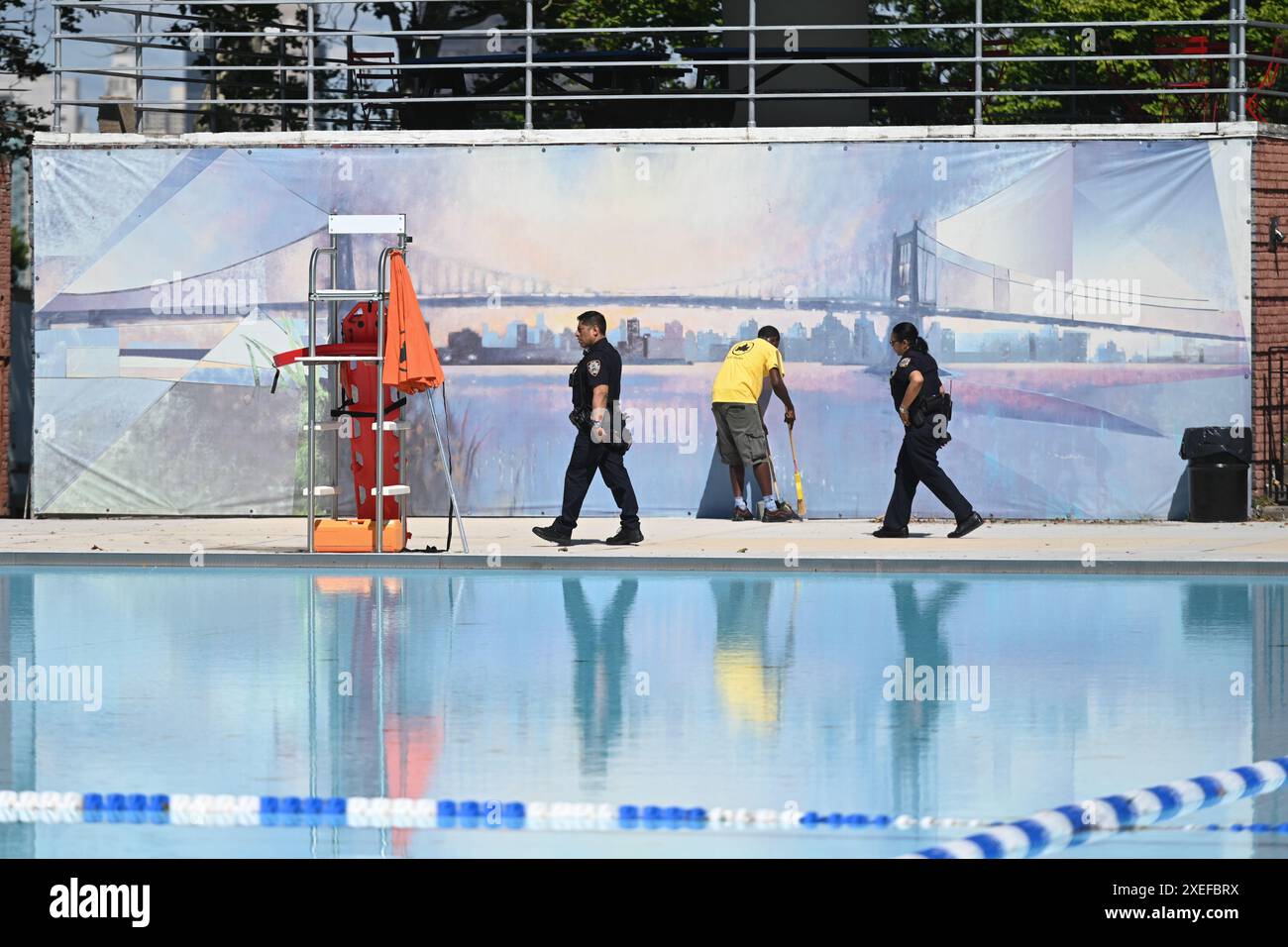 Police officers patrol the pool deck at the reopening of Astoria Pool ...