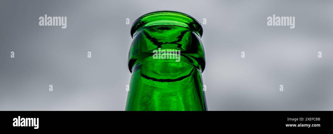 Low-angle perspective captures the bottleneck of an empty green beer ...