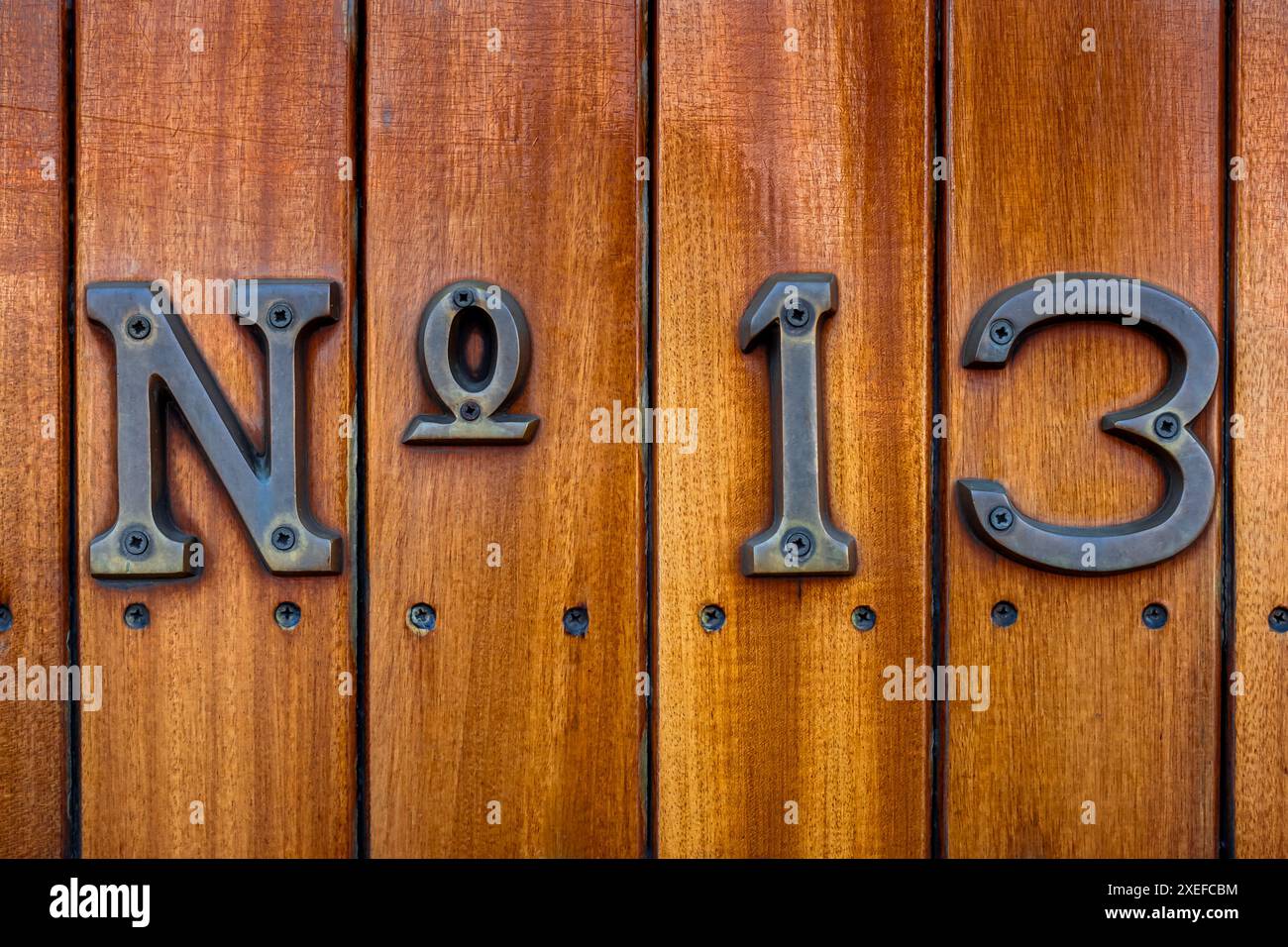 Weathered No 13 sign on the wooden surface of a train wagon, evoking a ...