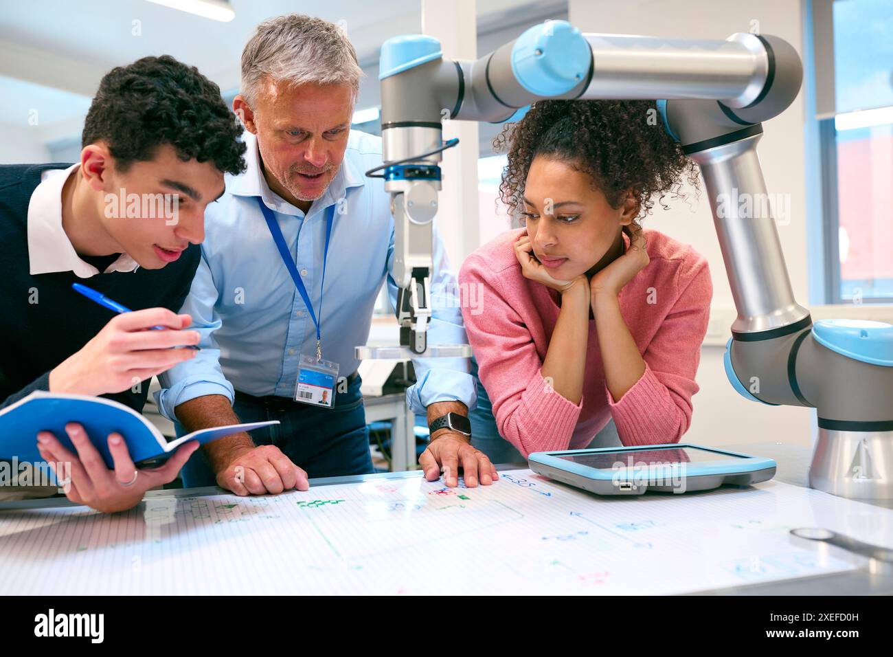 Two College Or University Engineering Students And Male Teacher In ...