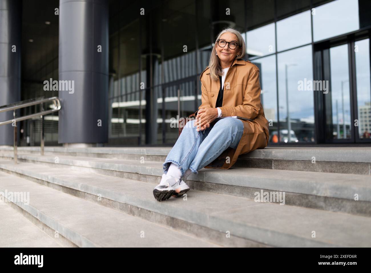 Confident mature adult female accountant with gray hair sitting on ...