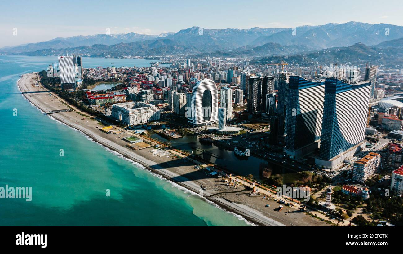 Coastal city featuring modern high-rise buildings, scenic beach, and ...