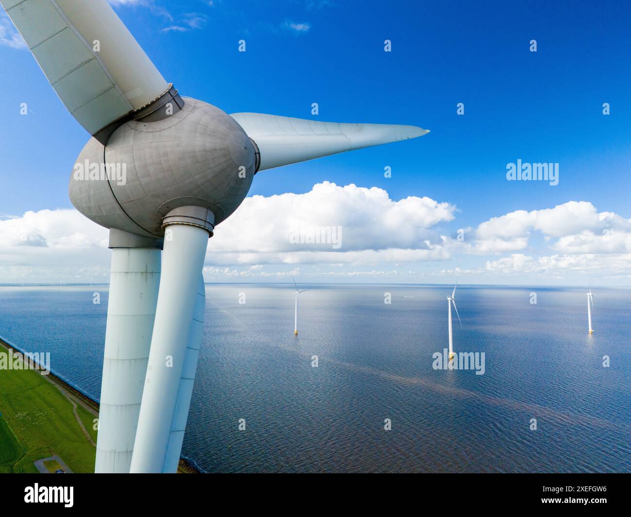 An aerial perspective captures the graceful movement of a wind turbine ...