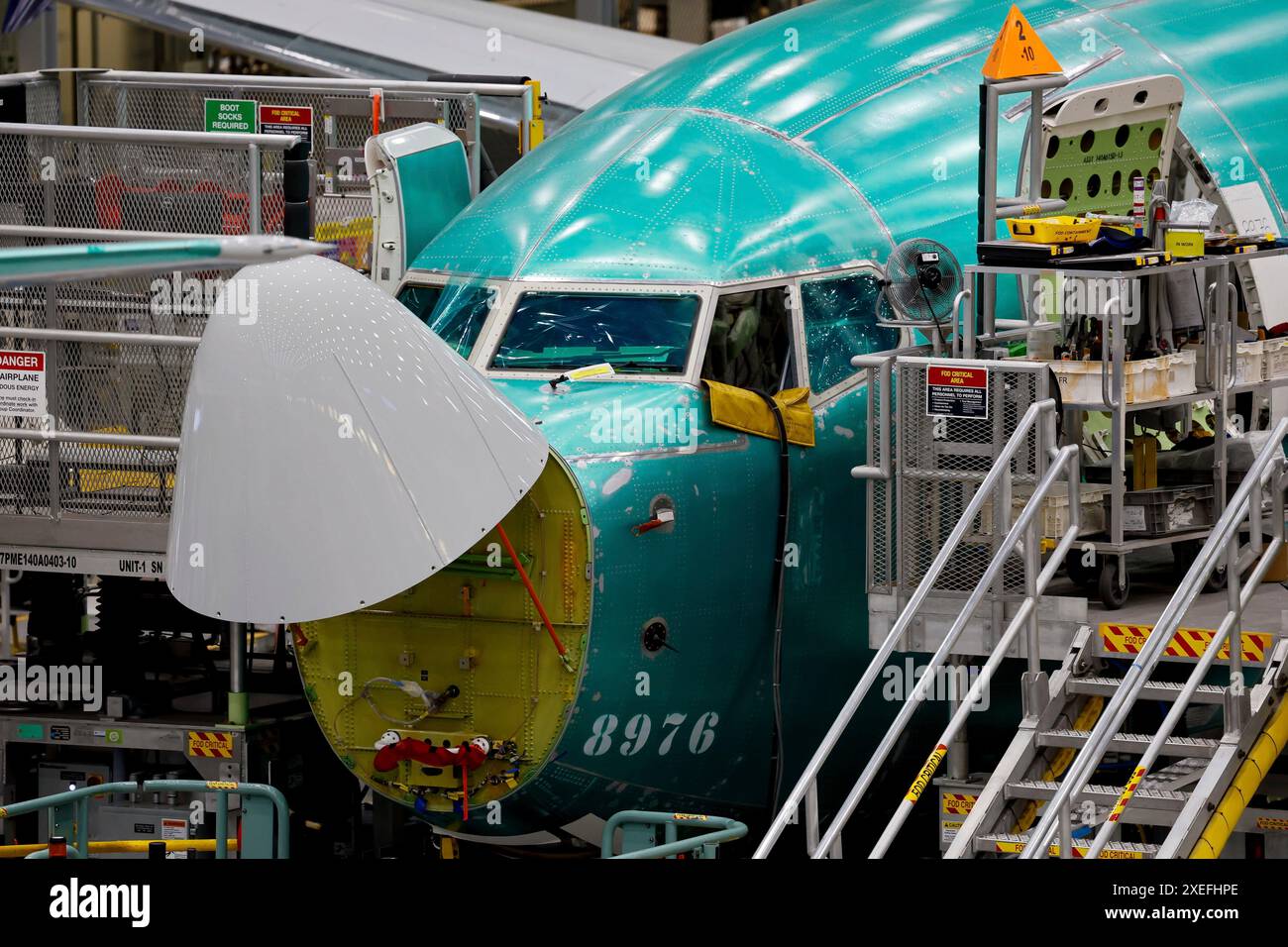 A Boeing 737 MAX aircraft is shown on the assembly line during a brief ...