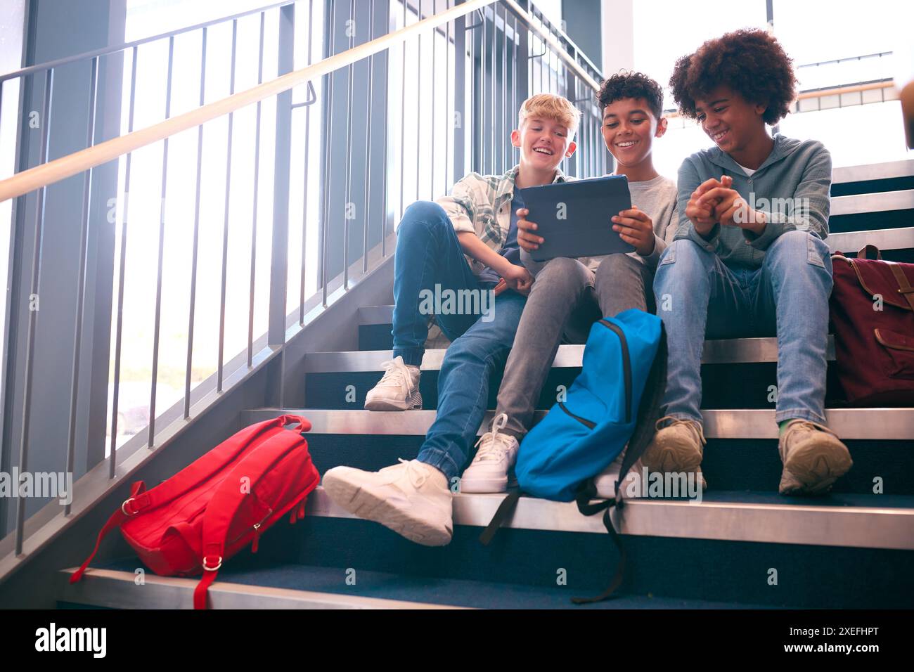 Three Male Secondary Or High School Pupils Inside School Building On ...