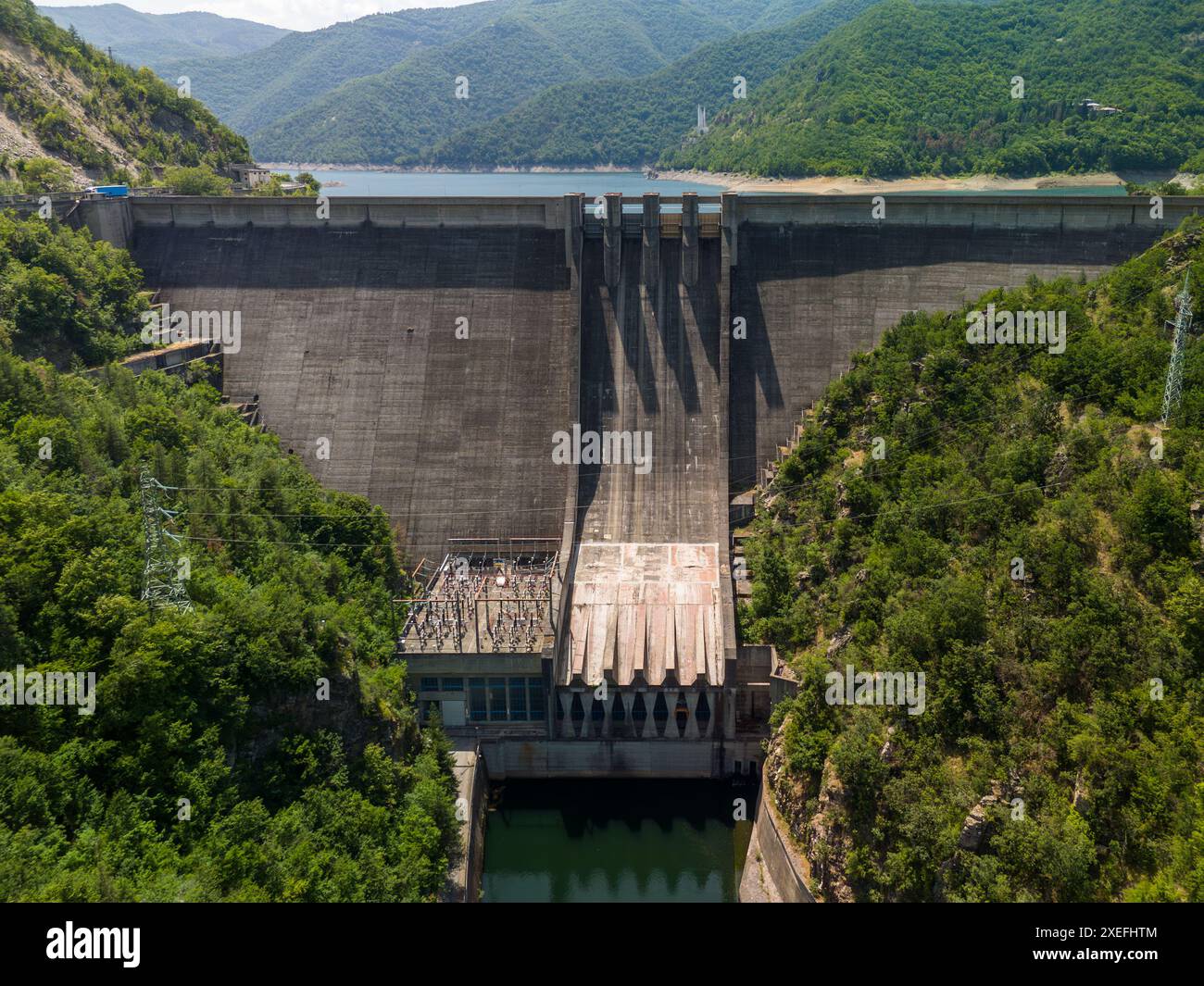 Aerial view of a hydroelectric power plant dam holding back water and ...