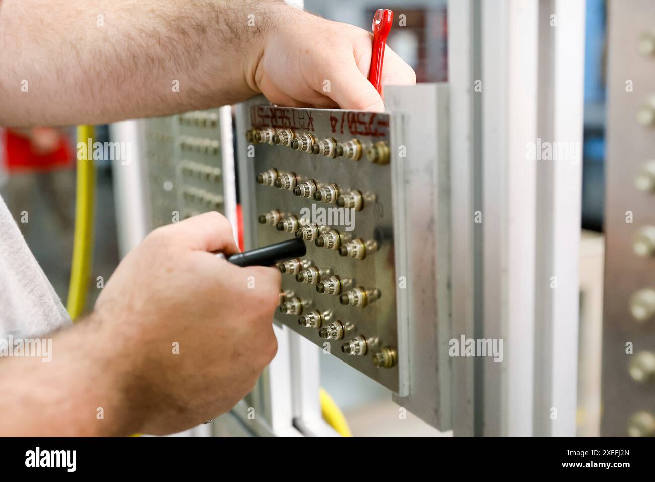 Gregory Oakes works on correctly torquing bolts during a brief media ...
