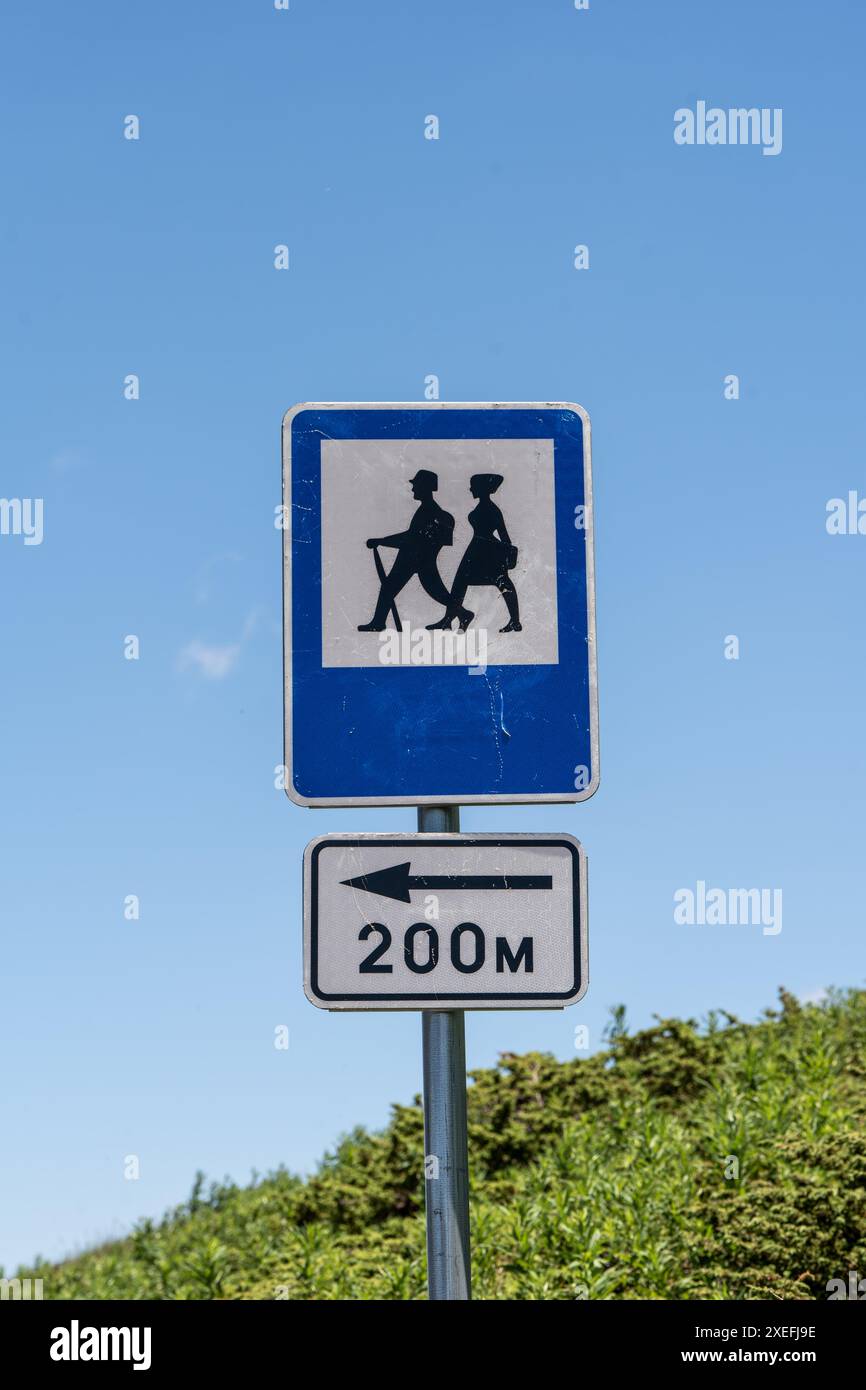 Blue and white pedestrian crossing sign indicating 200 meters to ...