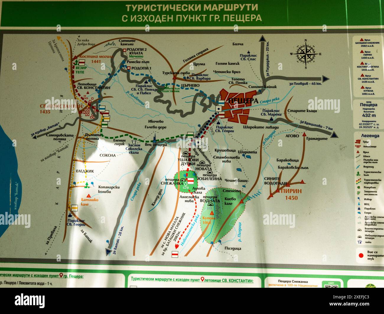 Sunlight illuminating a hiking map with cyrillic text showing trails ...
