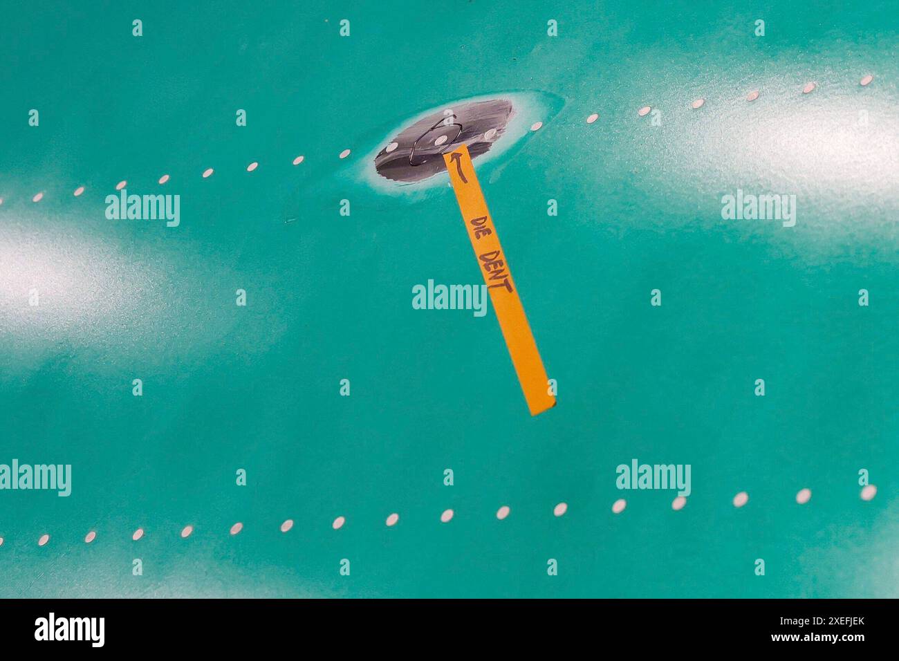 Orange tape marks a defect on the skin that requires rework on a 737 ...