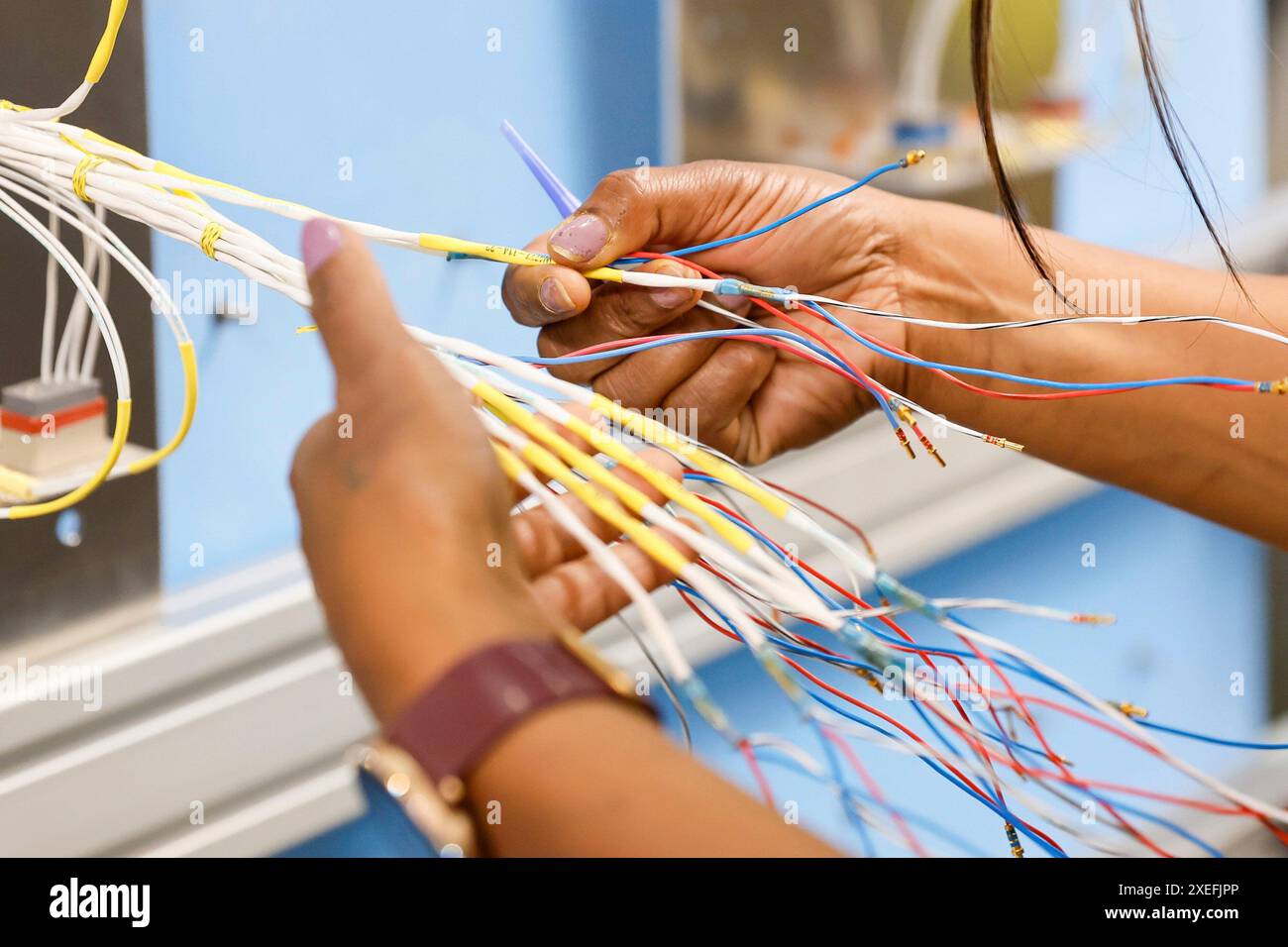 Moushmi Sharma trains on electrical wiring during a brief media tour at ...