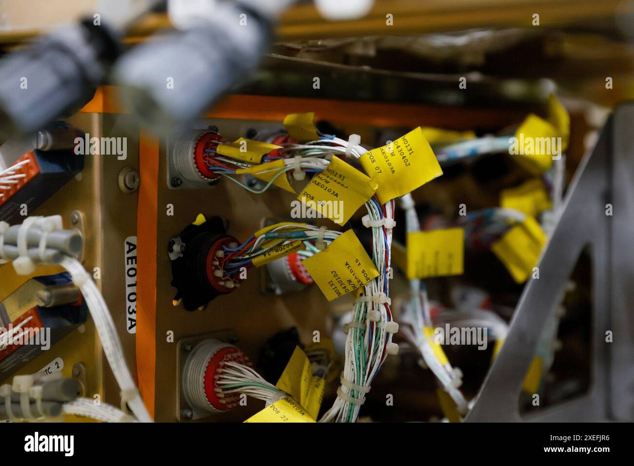 Bundled wires are seen inside the lower half, or E & E (electrical and ...