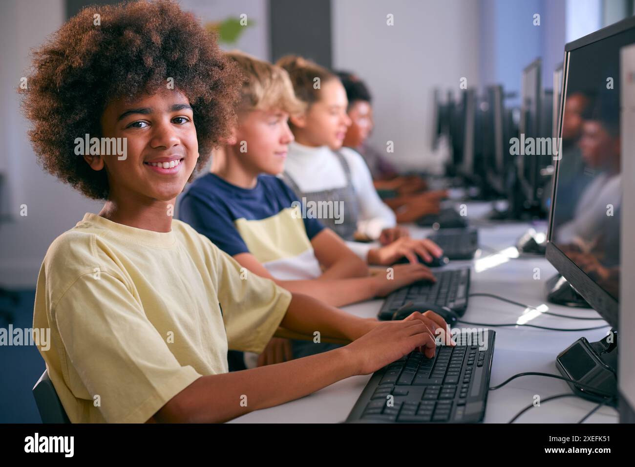 Portrait Of Male Secondary Or High School Student Sitting At Computer ...