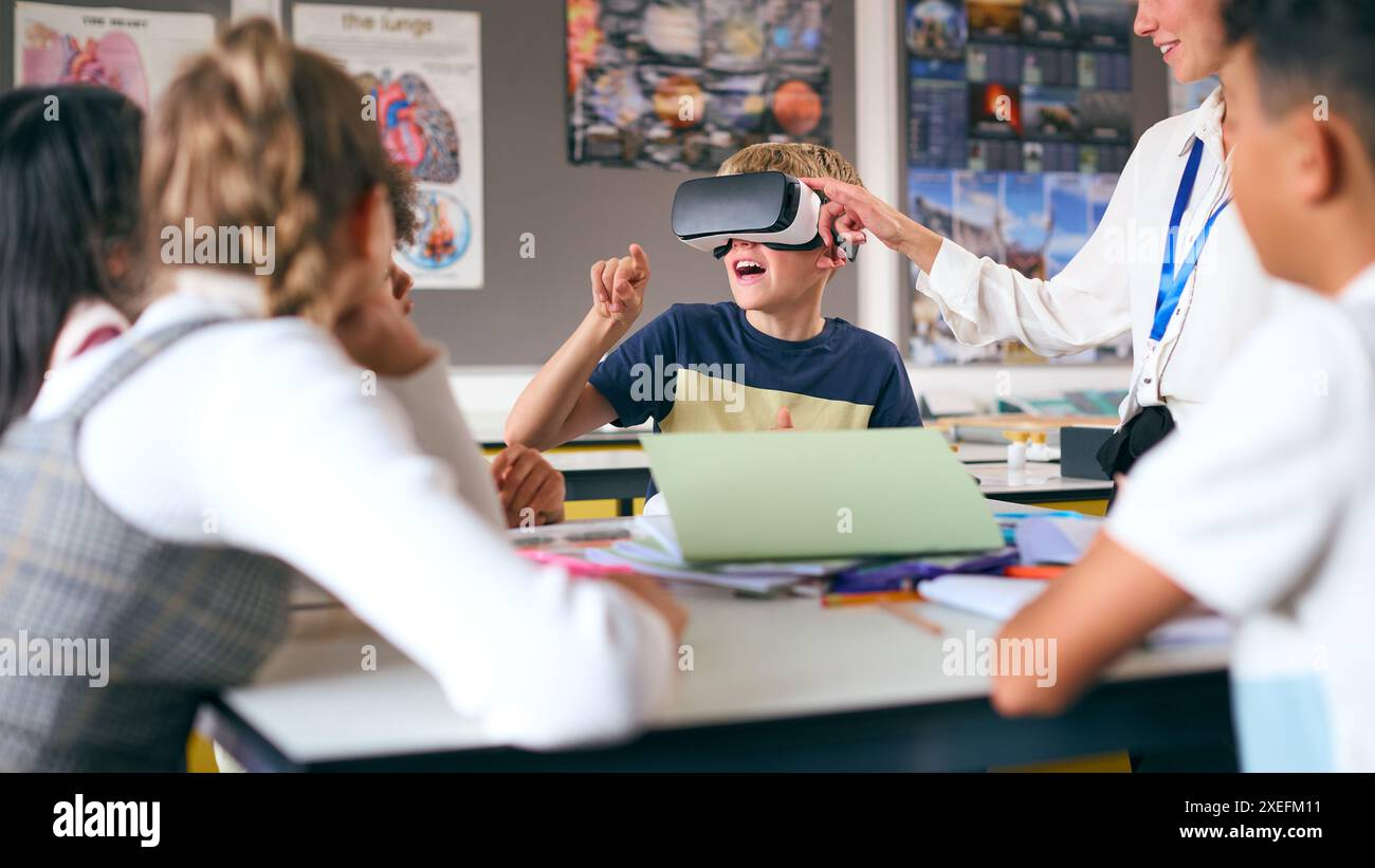 Amazed Male Secondary Or High School Pupil Wearing VR Headset In ...