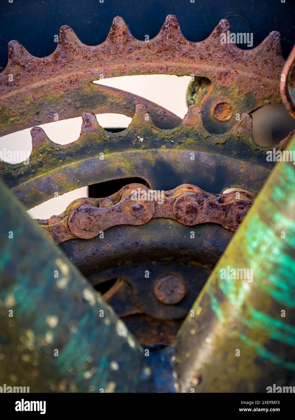 A close-up reveals the deteriorated state of the front chainrings and ...