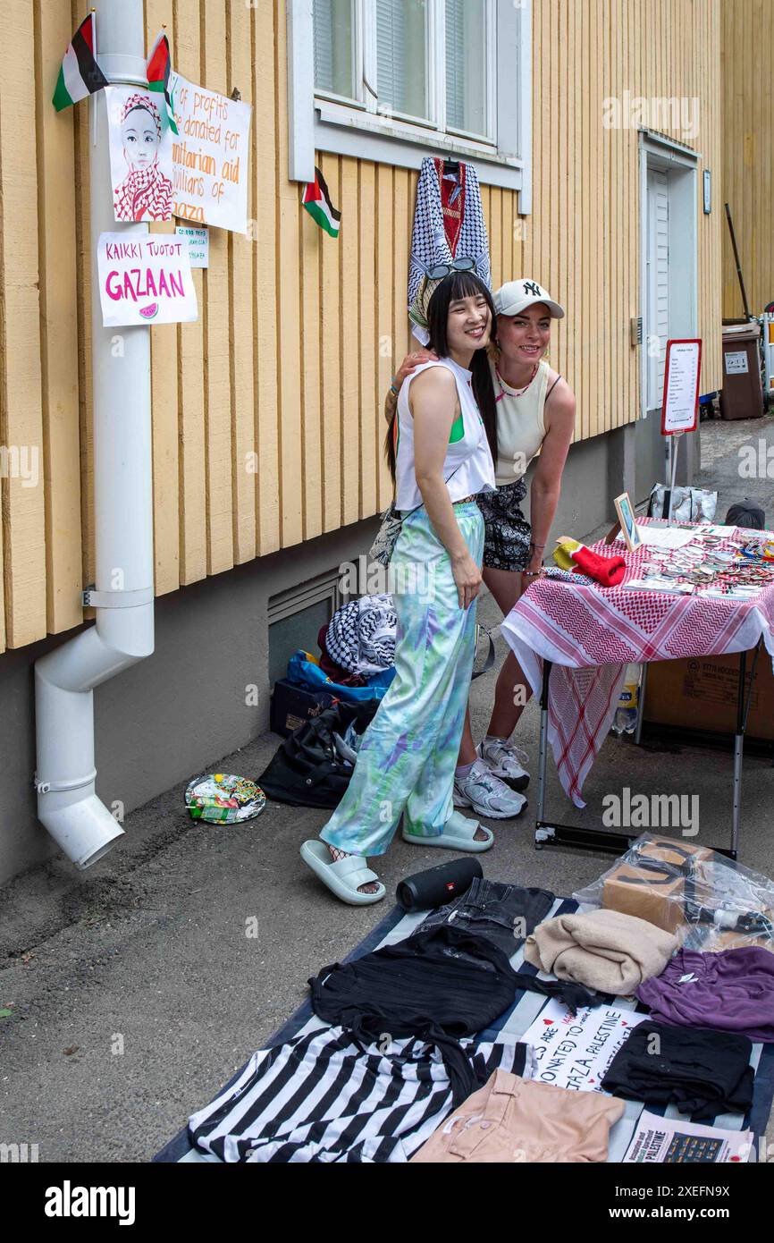 Young women selling used goods at Kumpula Village Party street fair pop ...