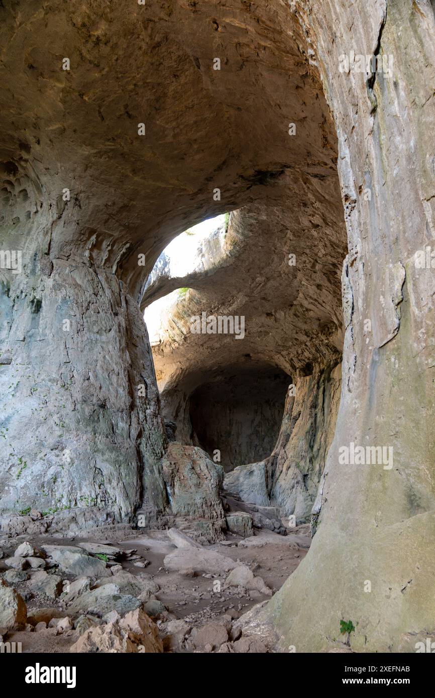 Sunlight is illuminating a network of caves showing layers of ...